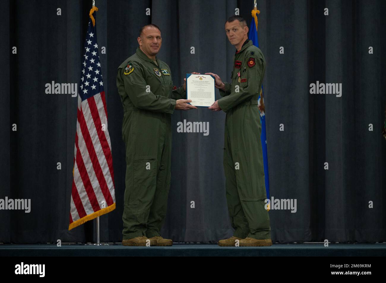 Lt. Col. Christopher Duff, right, outgoing 96th Bomb Squadron commander, receives the Legion of ...