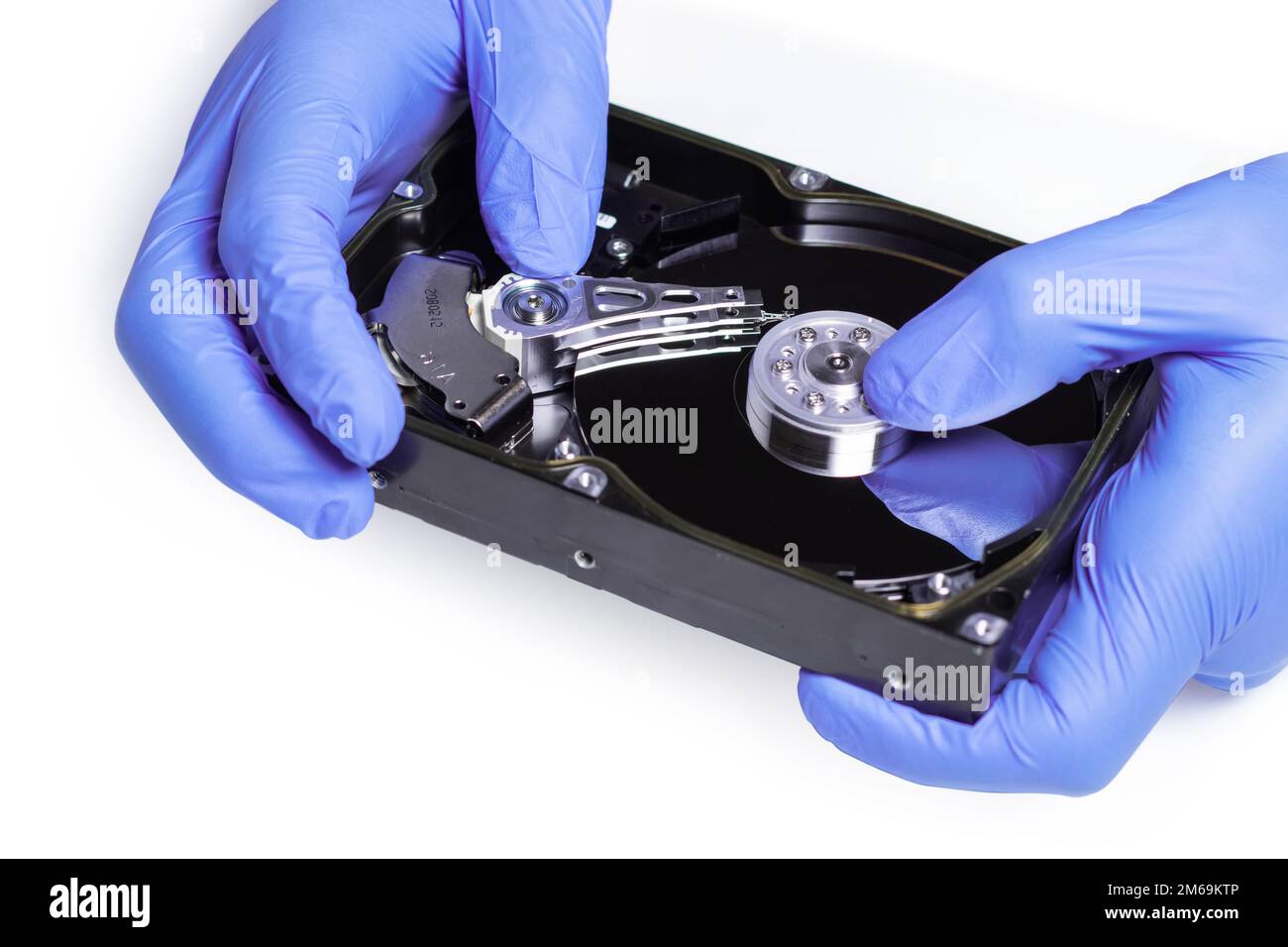 Repair Hard disk. Hands of master in gloves repair the computer hard ...