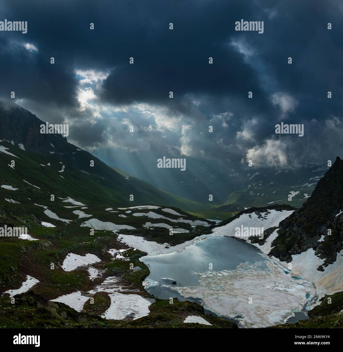 Rising sun is breaking through clouds over Azgara valley and mountain ...