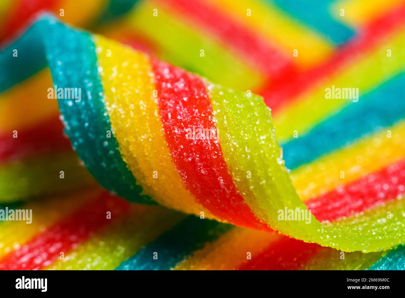 Colorful jelly candies strips in sugar sprinkles. Sour flavored rainbow ...