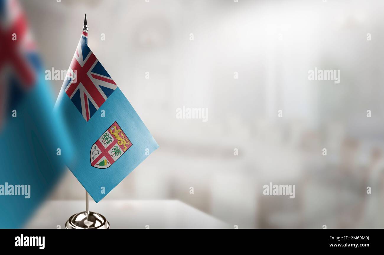 Small flags of the Fiji on an abstract blurry background Stock Photo ...