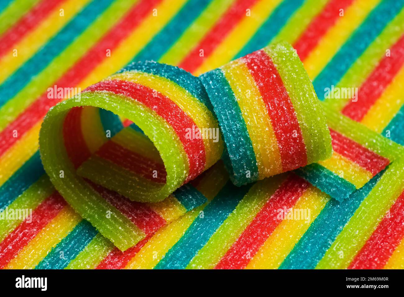 Colorful jelly candies strips in sugar sprinkles. Sour flavored rainbow ...