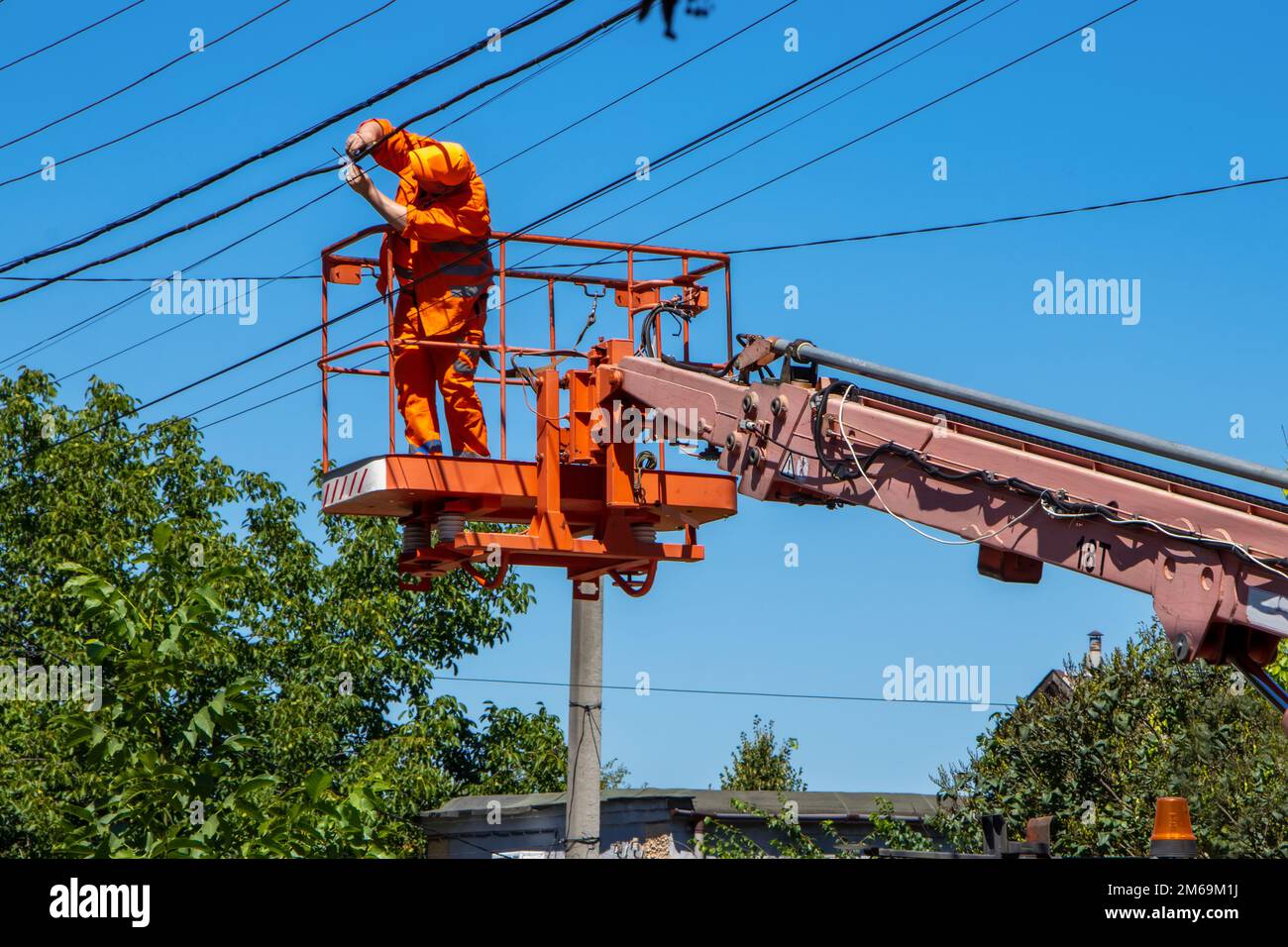 Electrician are climbing on electric poles to install and repair power ...
