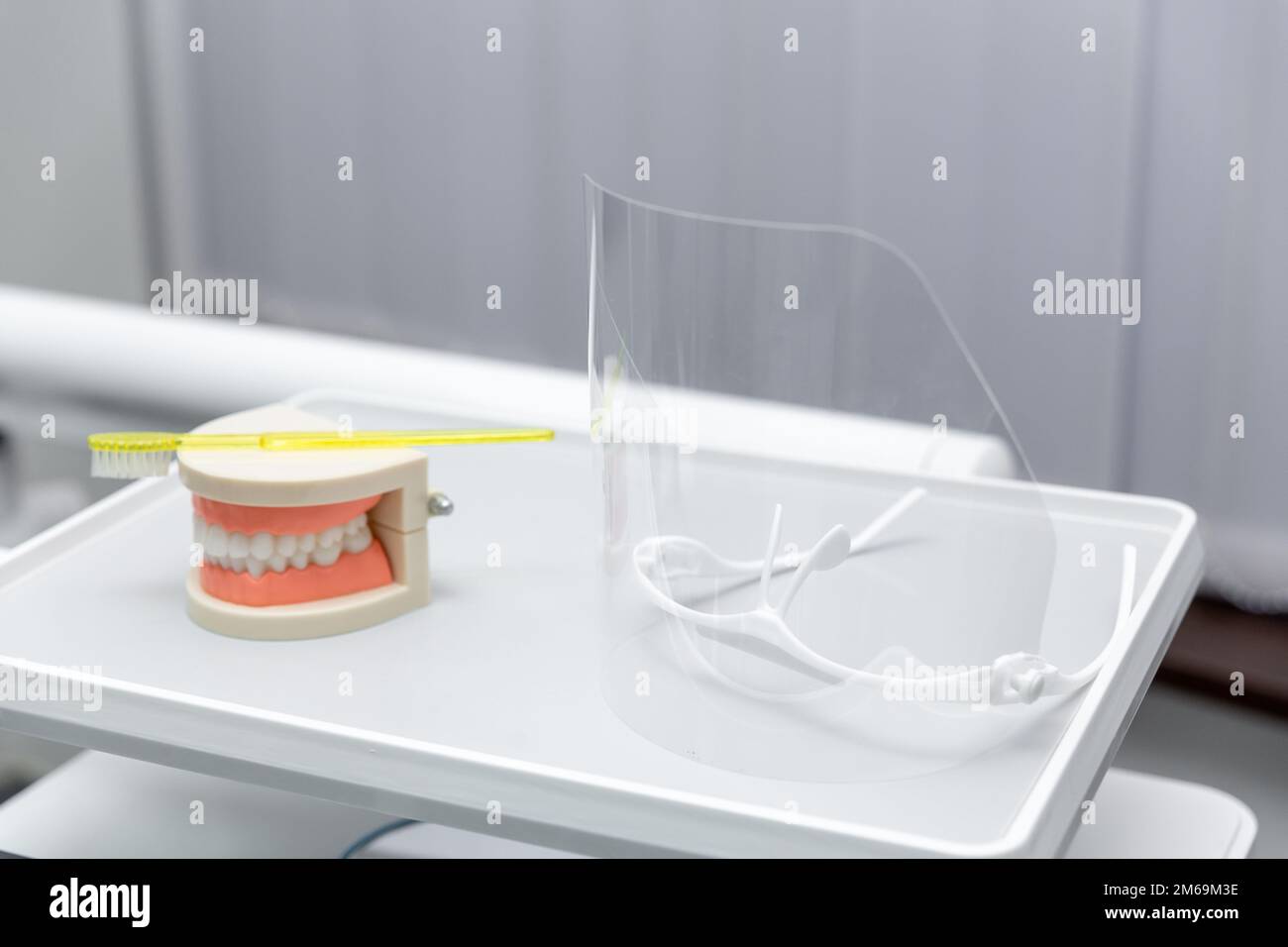 Clean teeth dental jaw model and yellow thooth brush on gray background ...