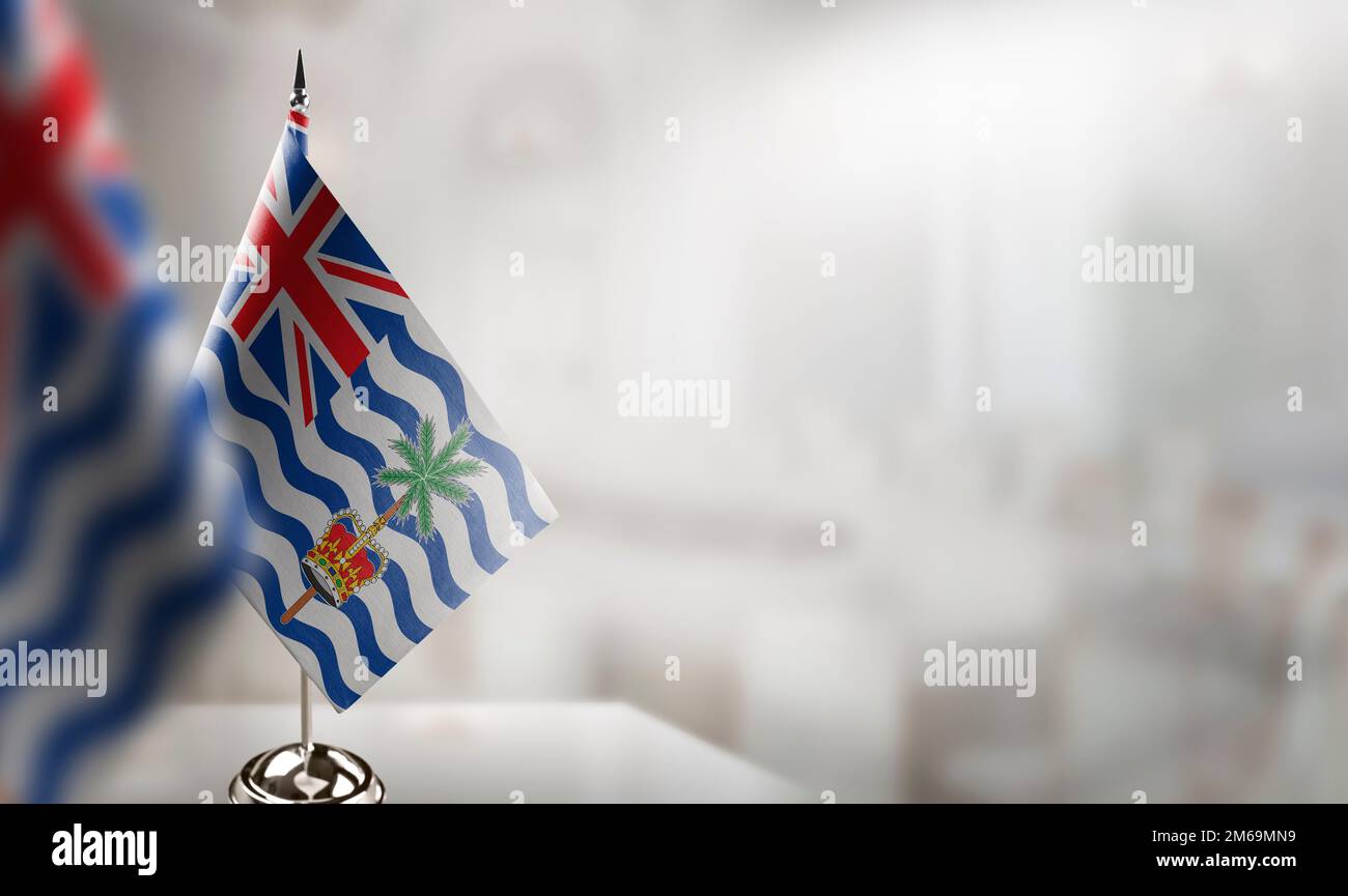 Small flags of the British Indian Ocean Territory on an abstract blurry ...