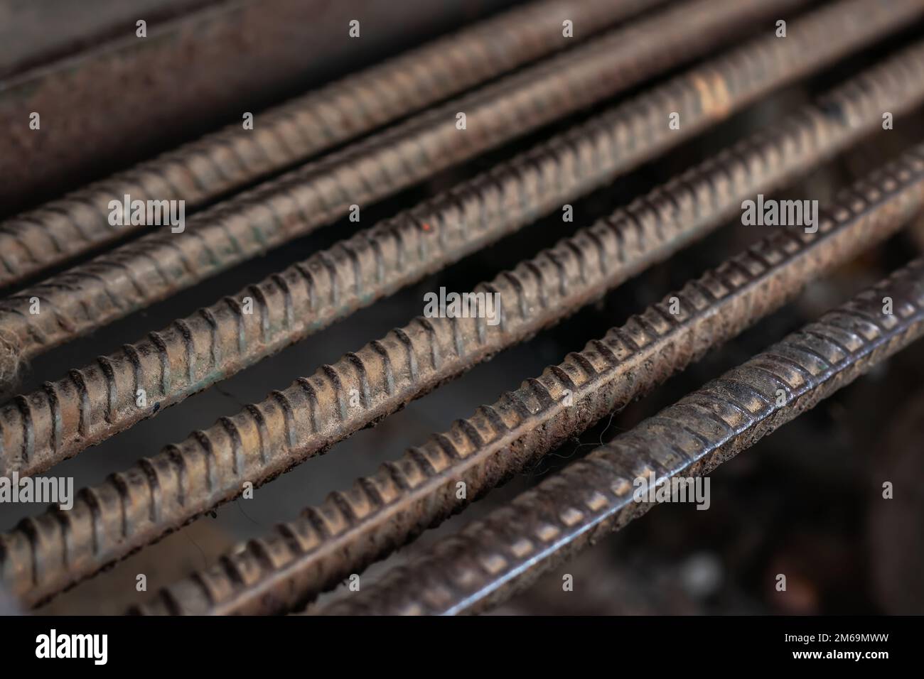 Stack of heavy metal reinforcement bars with periodic profile texture ...