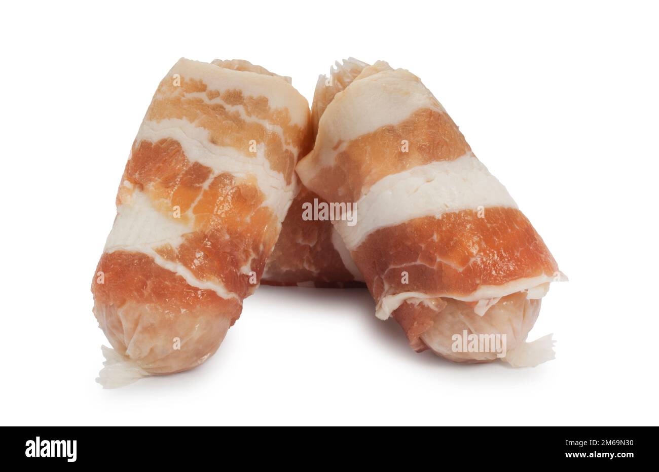 Studio shot of traditional pigs in blankets cut out against a white ...