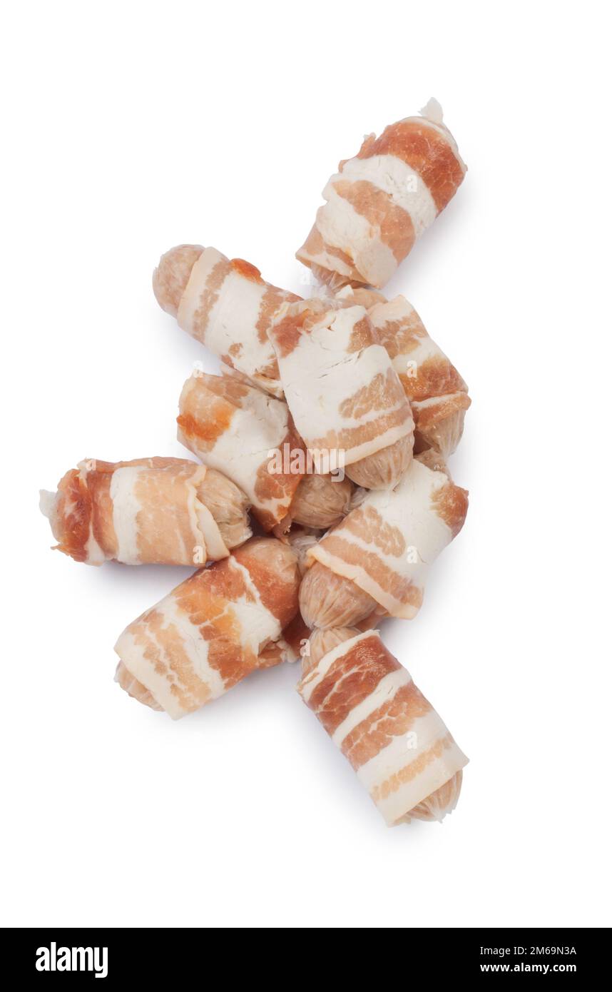 Studio shot of traditional pigs in blankets cut out against a white ...