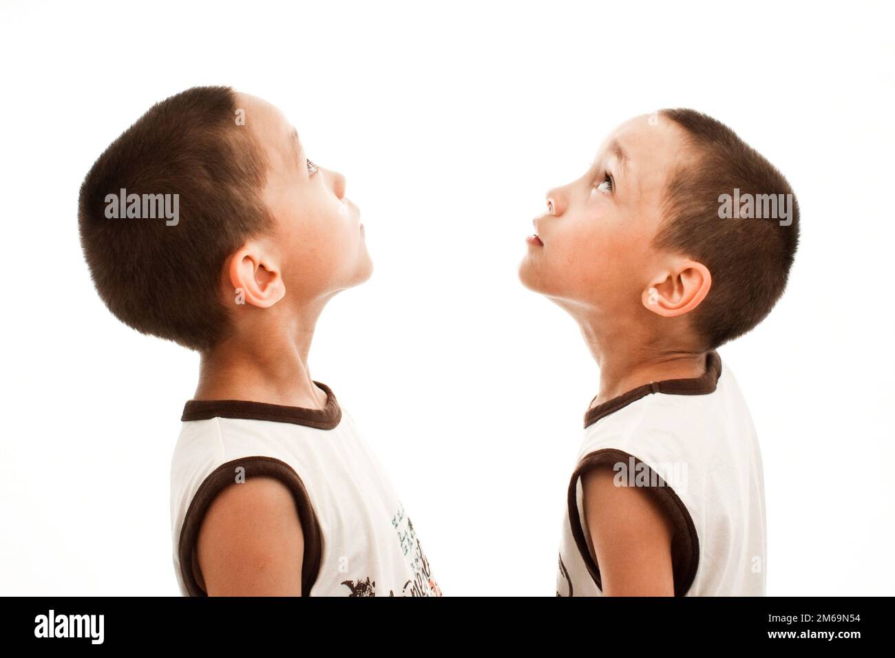 Twins looking up Stock Photo - Alamy