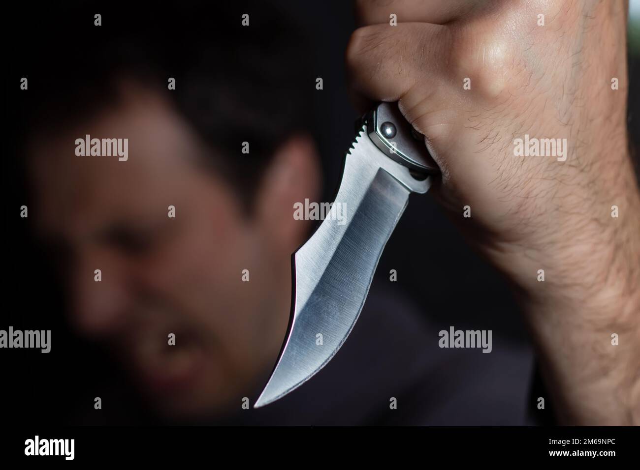 Knife in the hand of a man. Threat with knife. Man attack with knife ...