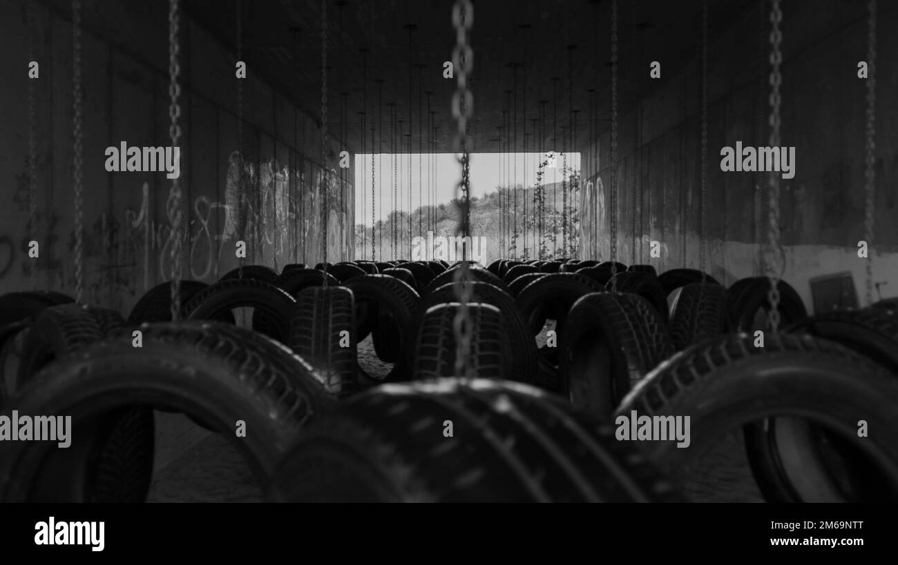 A room filled with lots of tires and chains hanging from the ceiling ...