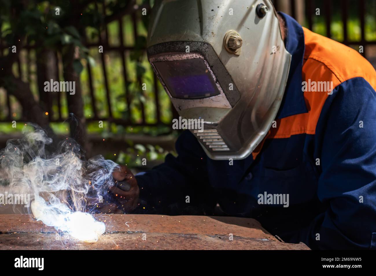 The man makes electric welding at home Stock Photo - Alamy