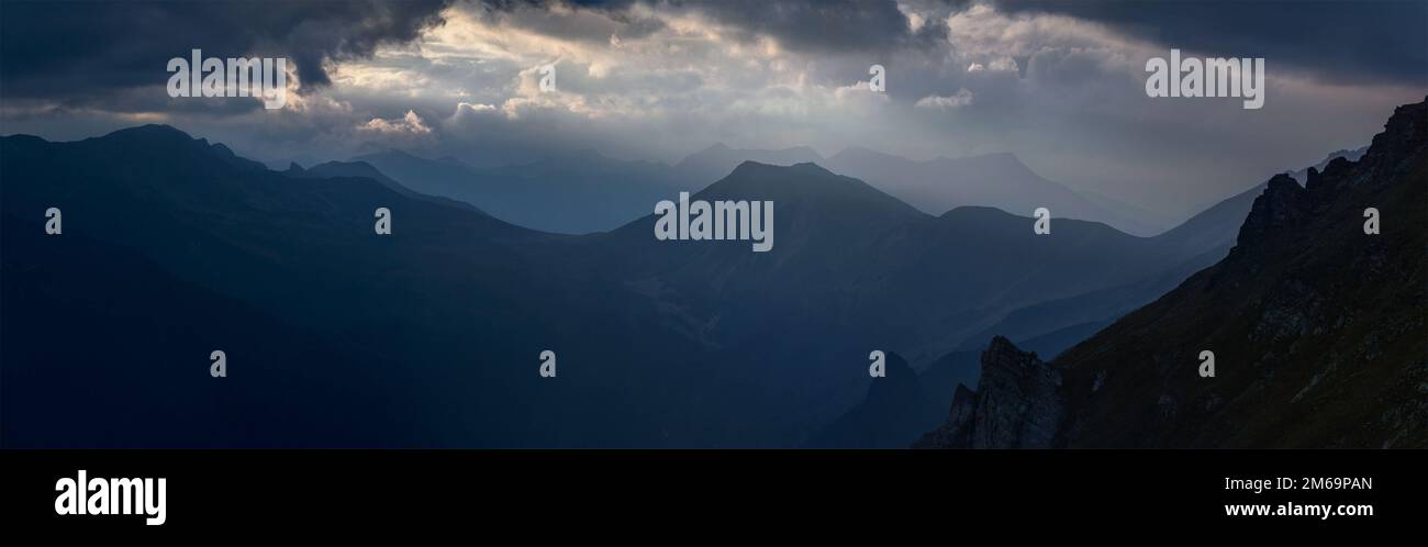 Silhouettes of ridges at sunset. View of Caucasus mountains from a ...
