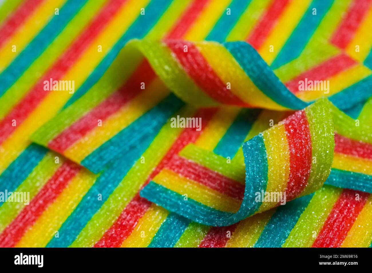 Rainbow sour jelly candies strips in sugar sprinkle Stock Photo - Alamy