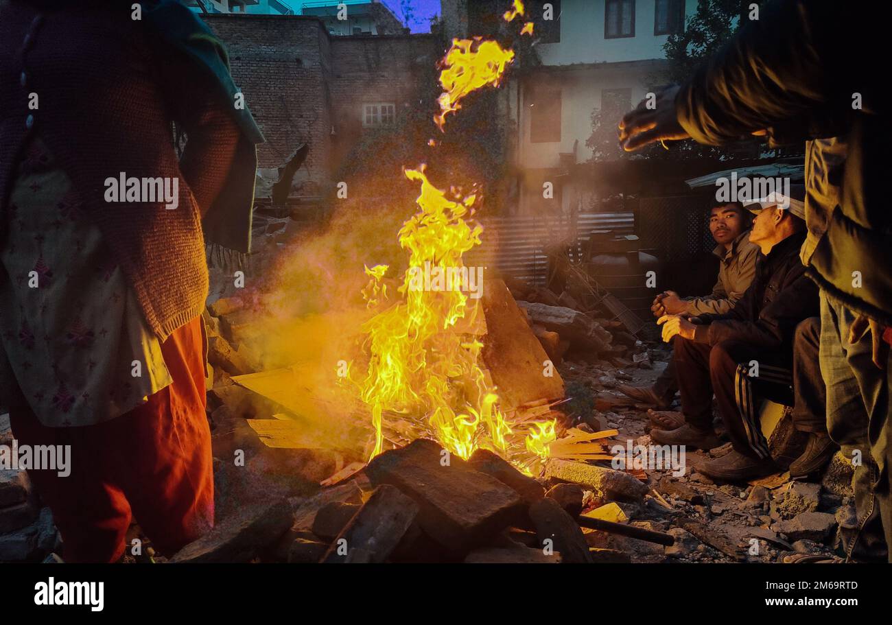Kathmandu, Bagmati, Nepal. 3rd Jan, 2023. People get warm by a fire on ...