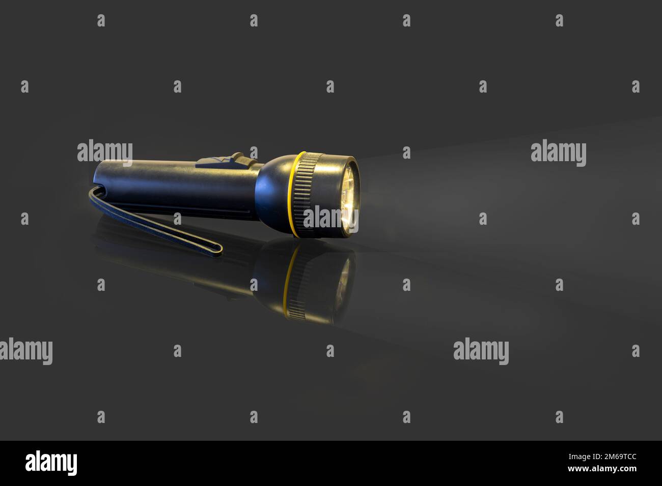 battery-powered flashlight on a black background Stock Photo - Alamy