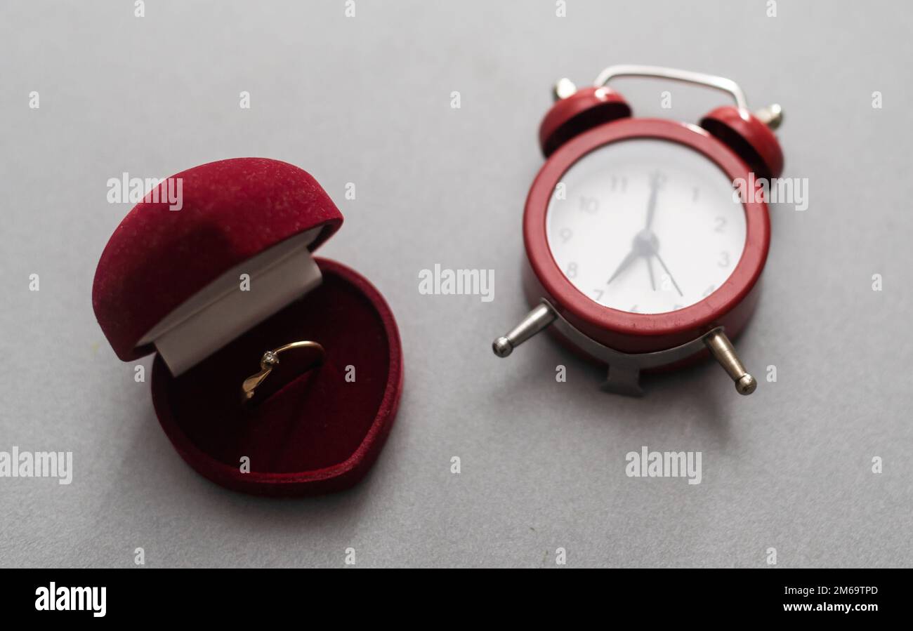 Wedding ring, alarm clock Tell time in life Stock Photo - Alamy