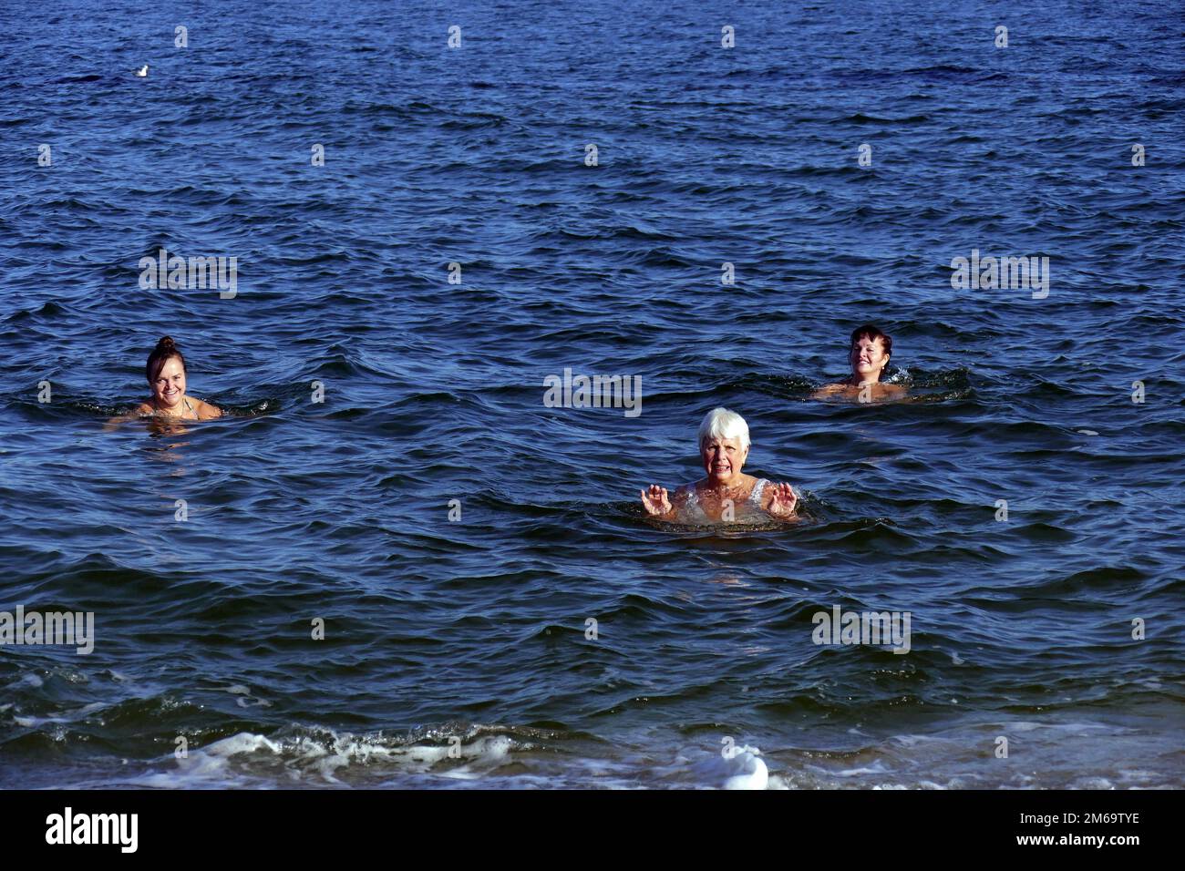 ODESA, UKRAINE - JANUARY 2, 2022 - Three women swim in the Black Sea in ...