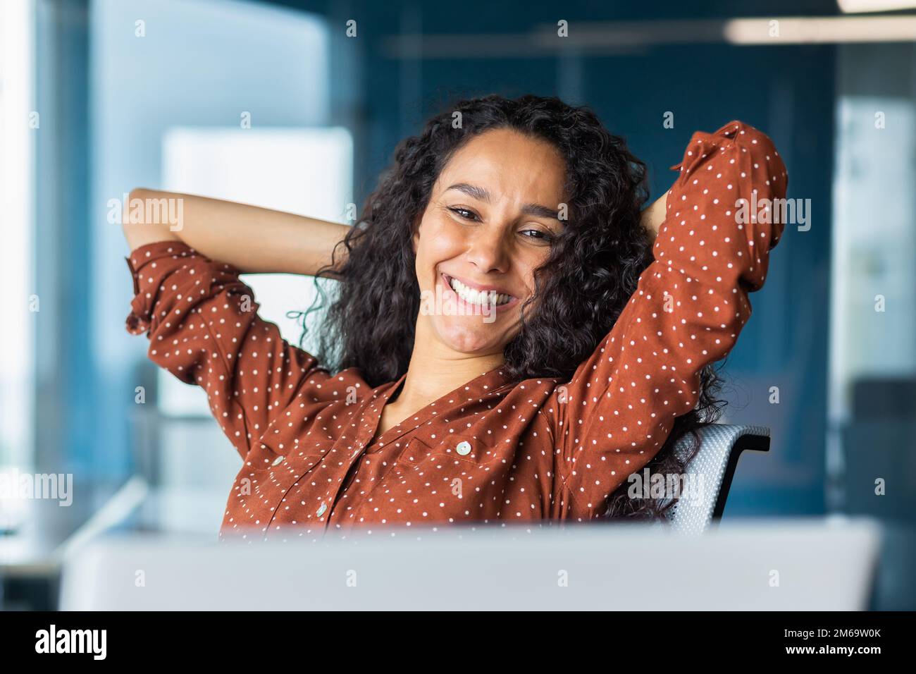 Happy and smiling successful hispanic business woman finished work ...