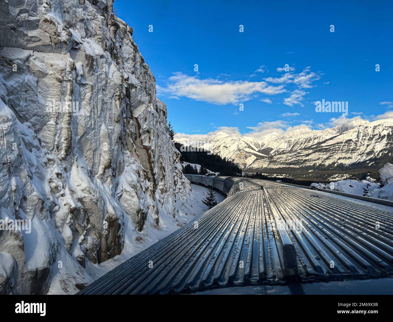 VIA Rail Train 2 leaving Jasper Station with mountains in the ...