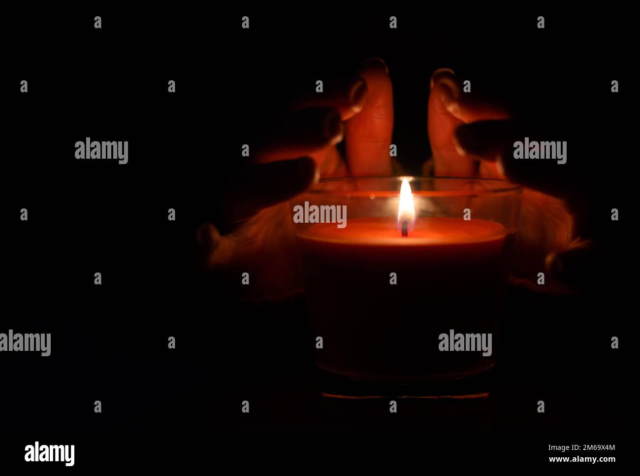 The candle is lit in a glass held by a beautiful woman in black ...