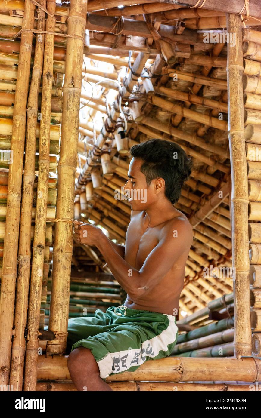 Sumbanese man constructs a traditional house using traditional methods ...