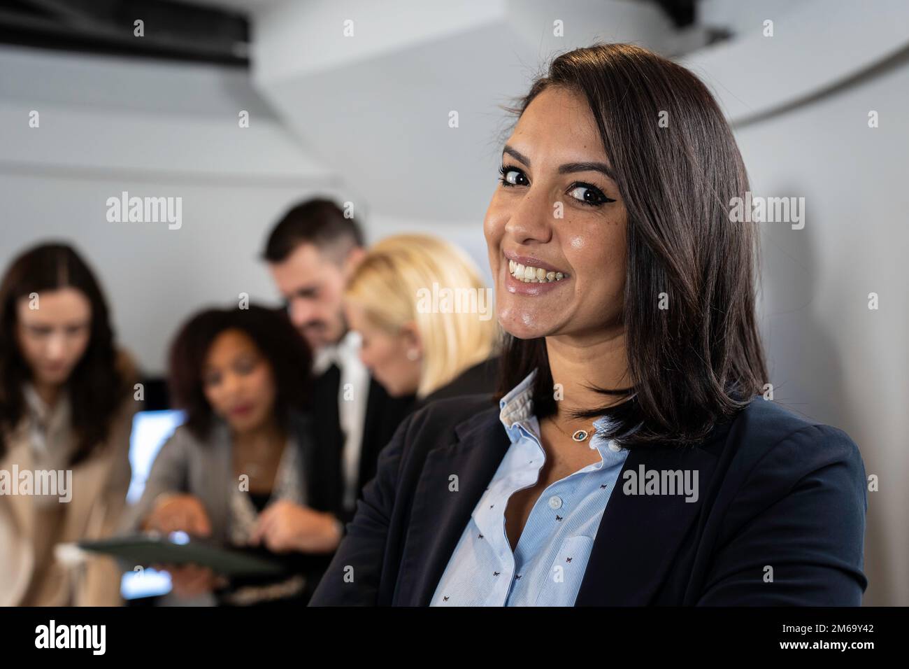 Smiling moroccan businesswoman working inside modern office with the ...