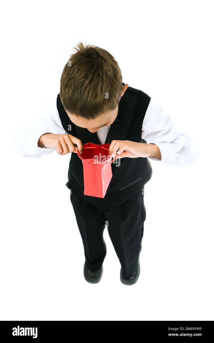 Boy holding red bag Stock Photo - Alamy