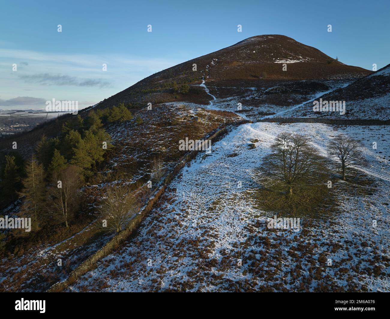 Aerial view of path leading to the summit of The Eildons on a crisp ...