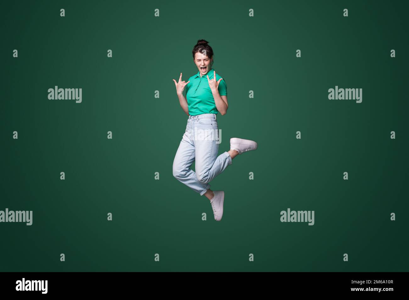 Full body photo of crazy funky woman jump up in air making horned signs ...