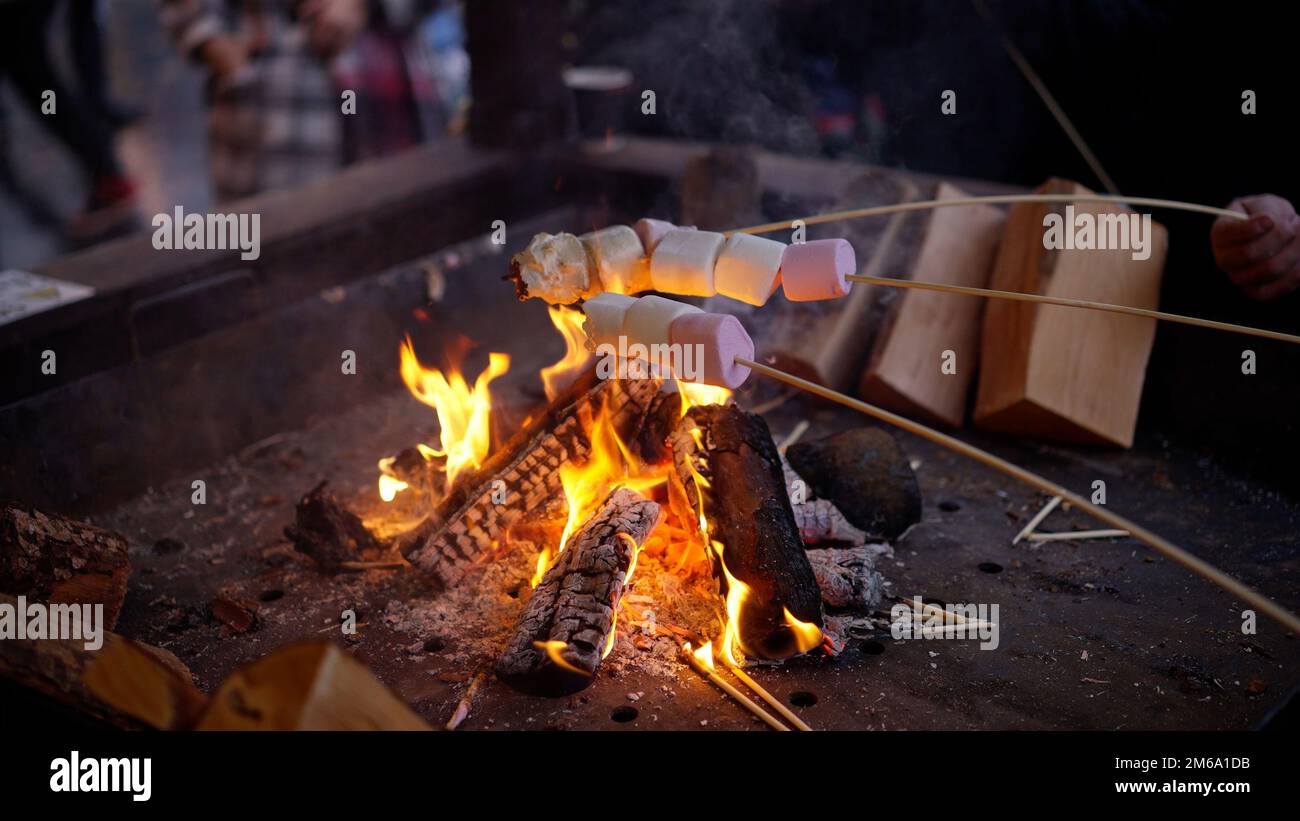 Toasting marshmallows over open fire - LONDON, UK - DECEMBER 20, 2022 ...