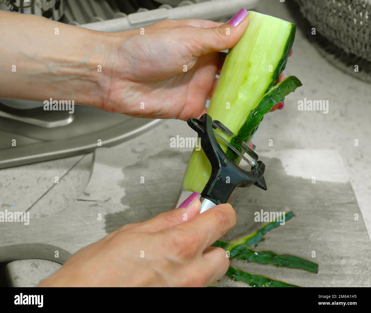 Peeling cucumber kitchen tool hi-res stock photography and images - Alamy