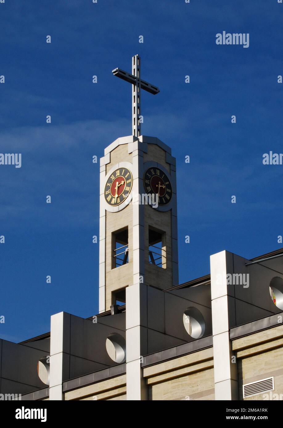 Cross and clock of modern Catholic Church on sky b Stock Photo - Alamy