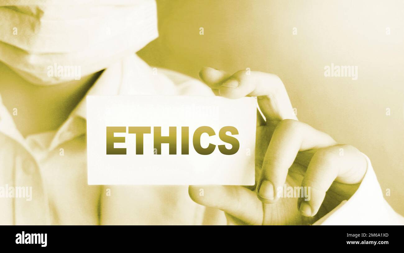 Ethics word on card in hands of Medical Doctor. Healthcare confirencial ...
