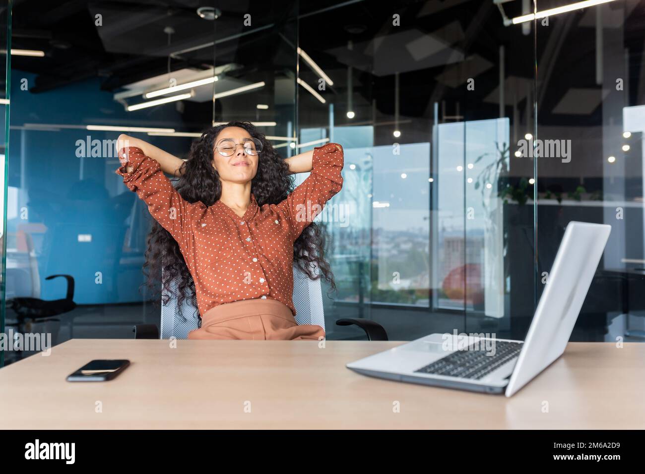 Hispanic business woman with closed eyes dreaming at workplace, close ...