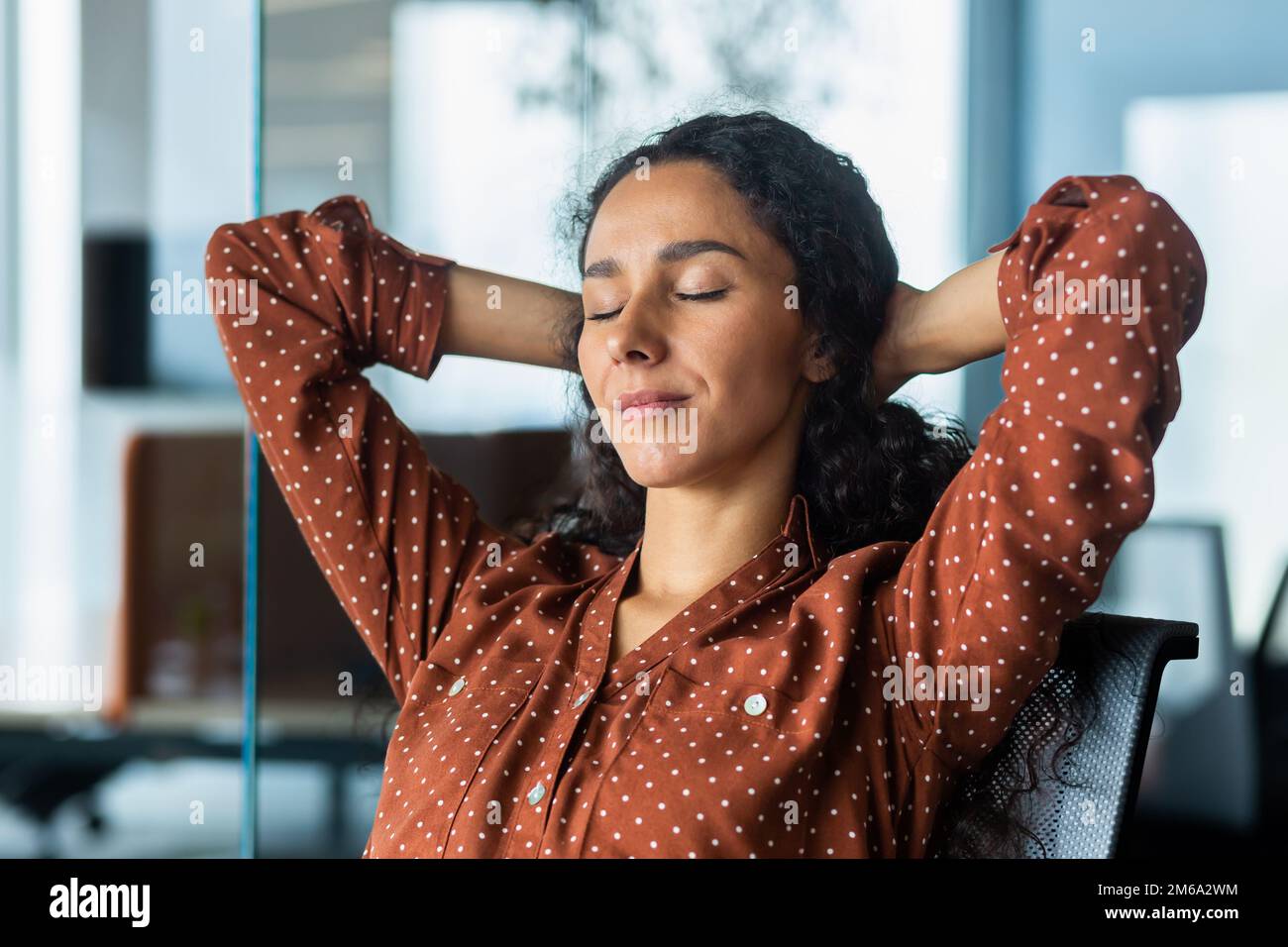 Hispanic business woman with closed eyes dreaming at workplace, close ...