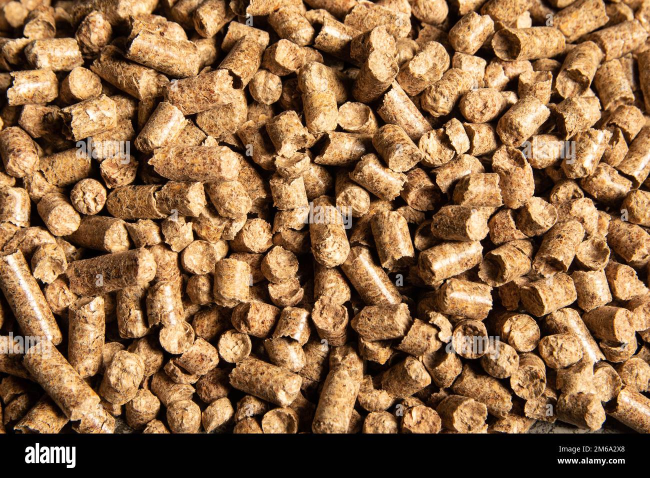 Pile of brown pellets for cat litter background Stock Photo - Alamy