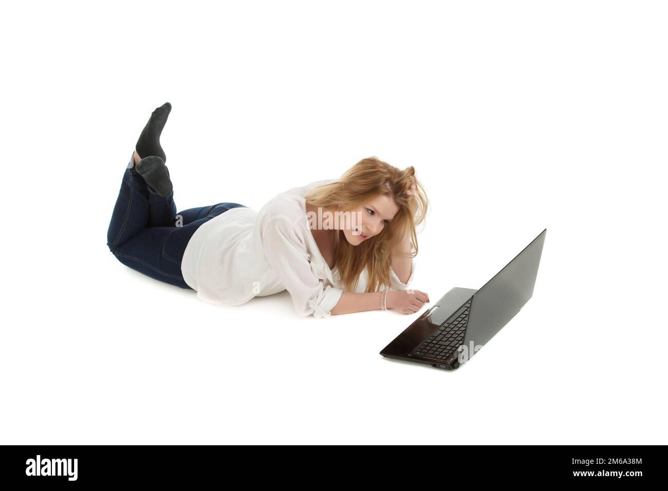 Young blonde woman lying with computer Stock Photo - Alamy