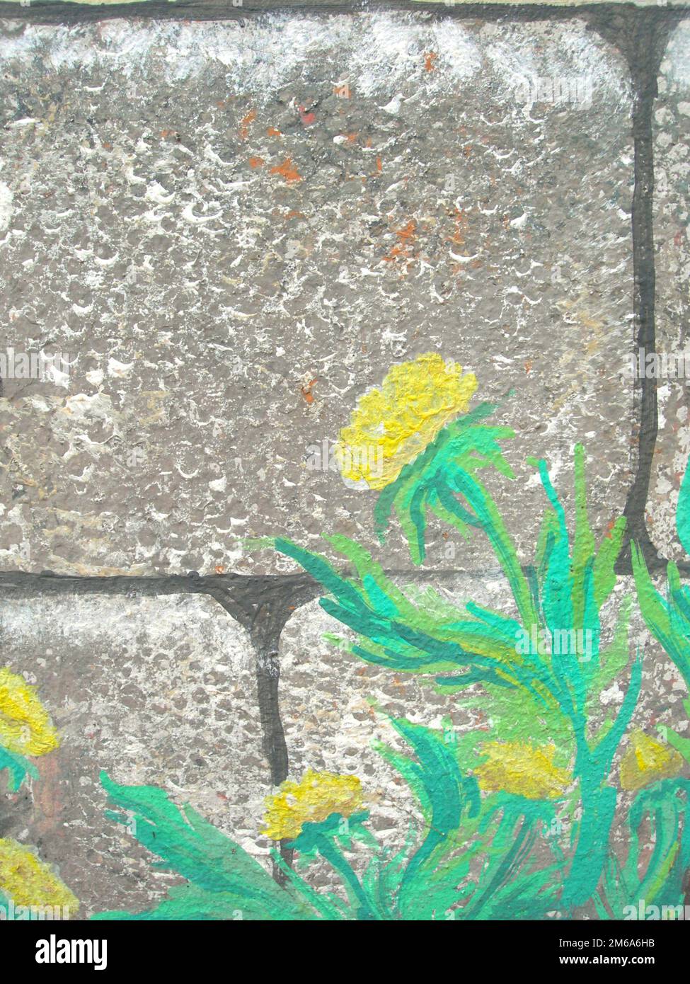 Old stone wall overgrown with painted flowers Stock Photo - Alamy