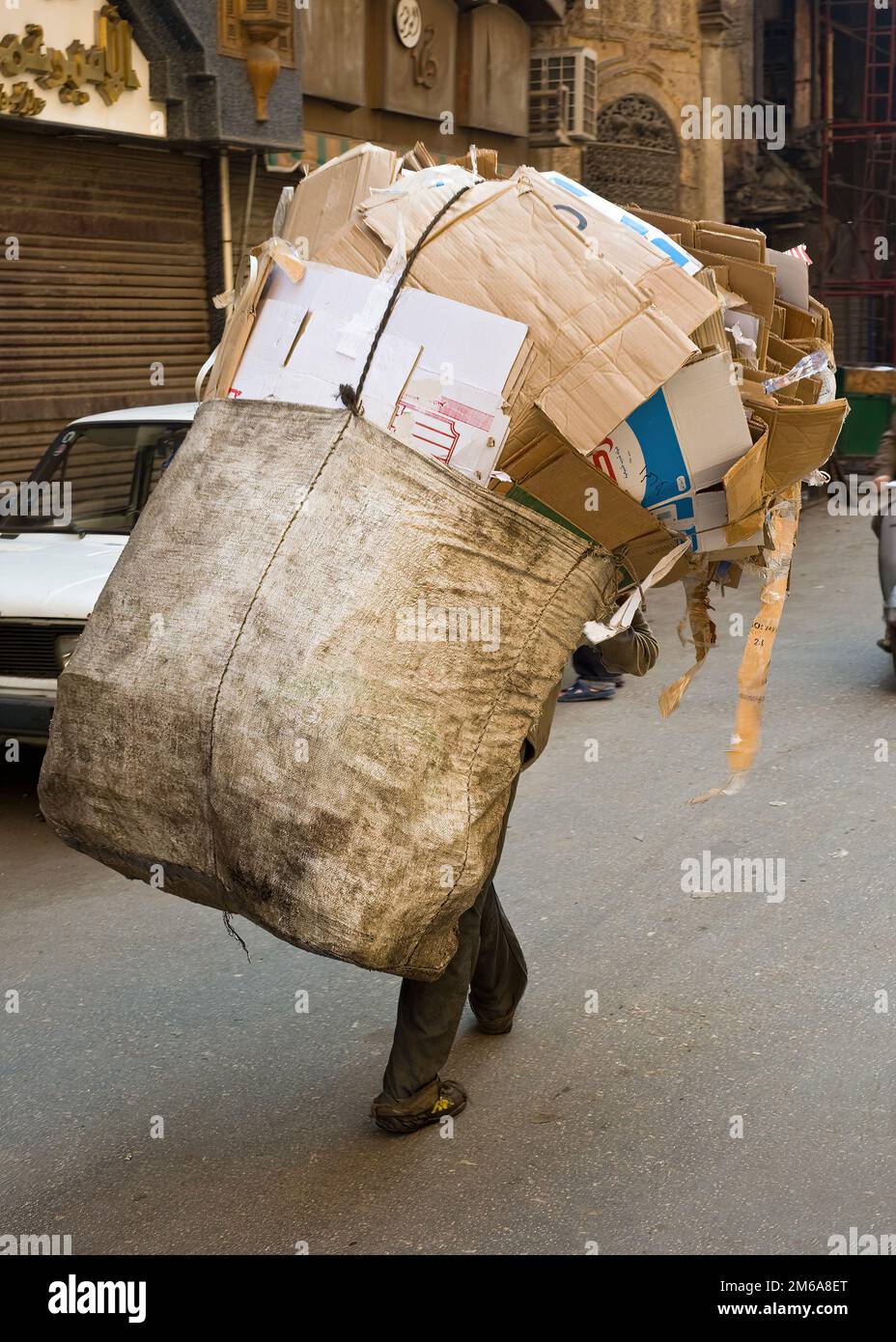 A man carrying a large amount of used cardboard on his back. Cairo ...