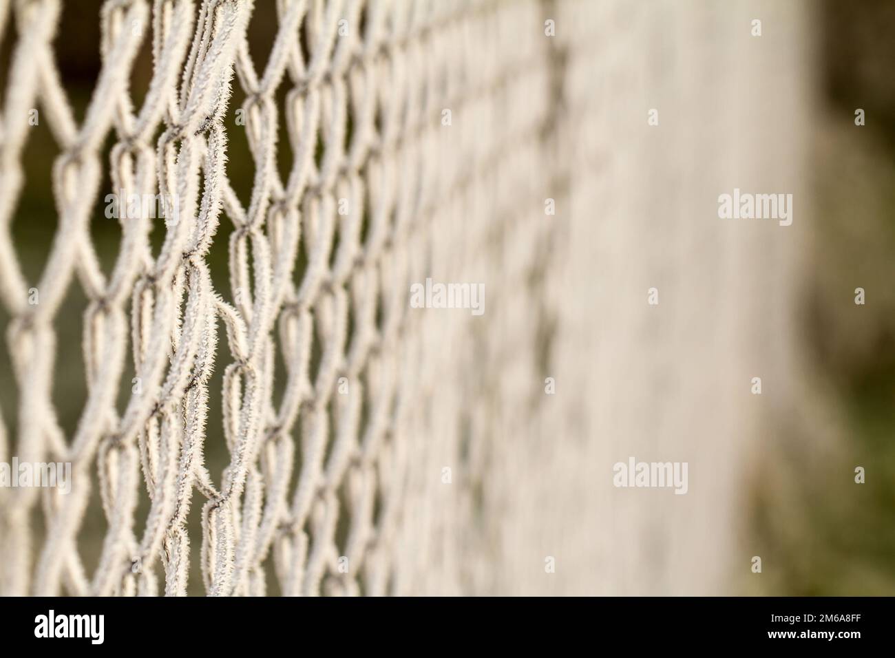 Wire fence texture with hoarfrost overlay Stock Photo - Alamy