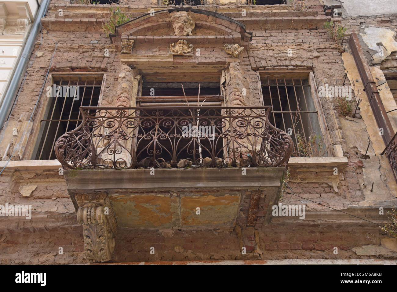 A derelict ruined empty stone built house with balcony in Bucharest ...