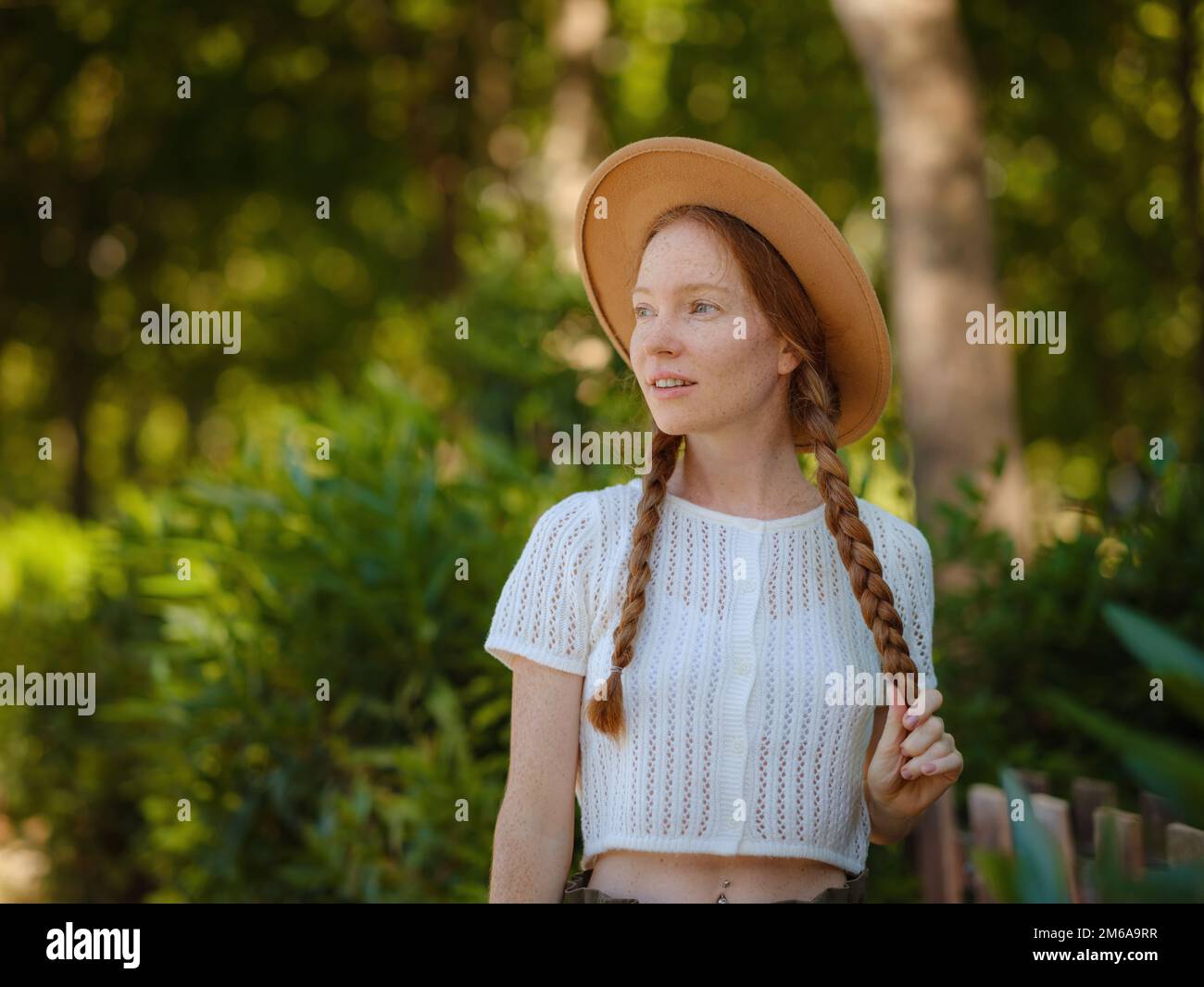 Caucasian ginger young beautiful woman in hat traveling alone ...