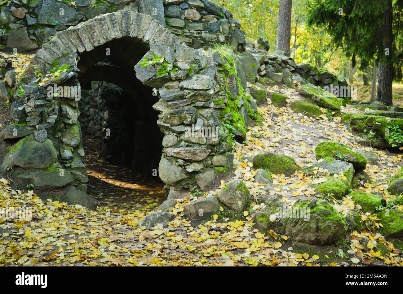 Input in a stone cave Stock Photo - Alamy