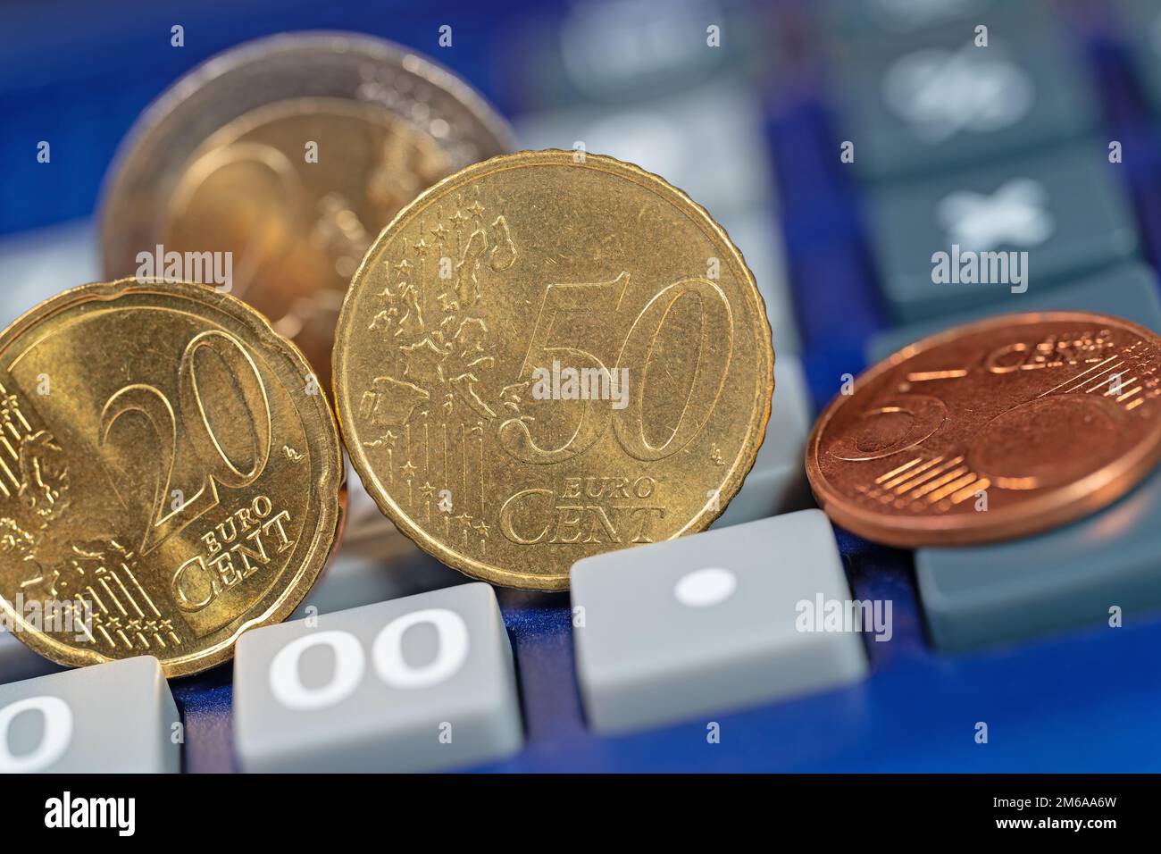 Euro coins on a pocket calculator Stock Photo - Alamy