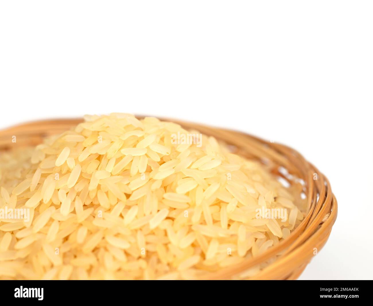 Rice grains in basket against white background Stock Photo - Alamy
