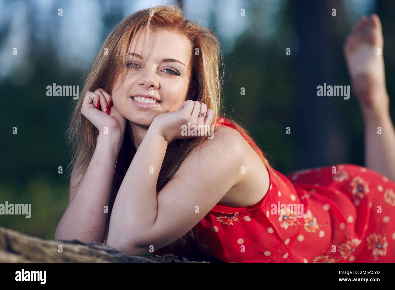 Woman lying on log outdoors hi-res stock photography and images - Alamy