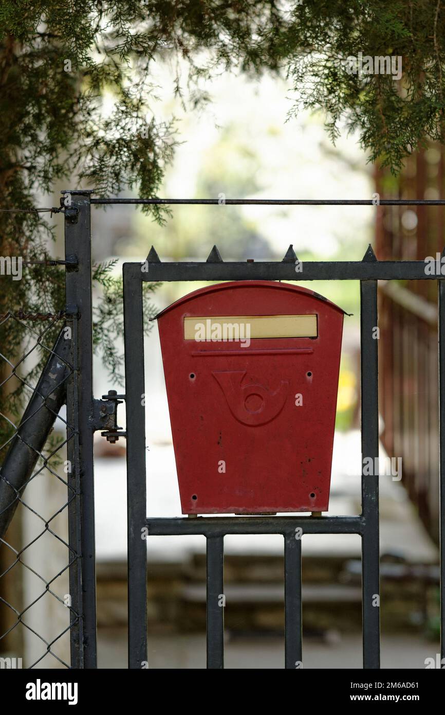 Red steel mailbox on the fence Stock Photo - Alamy