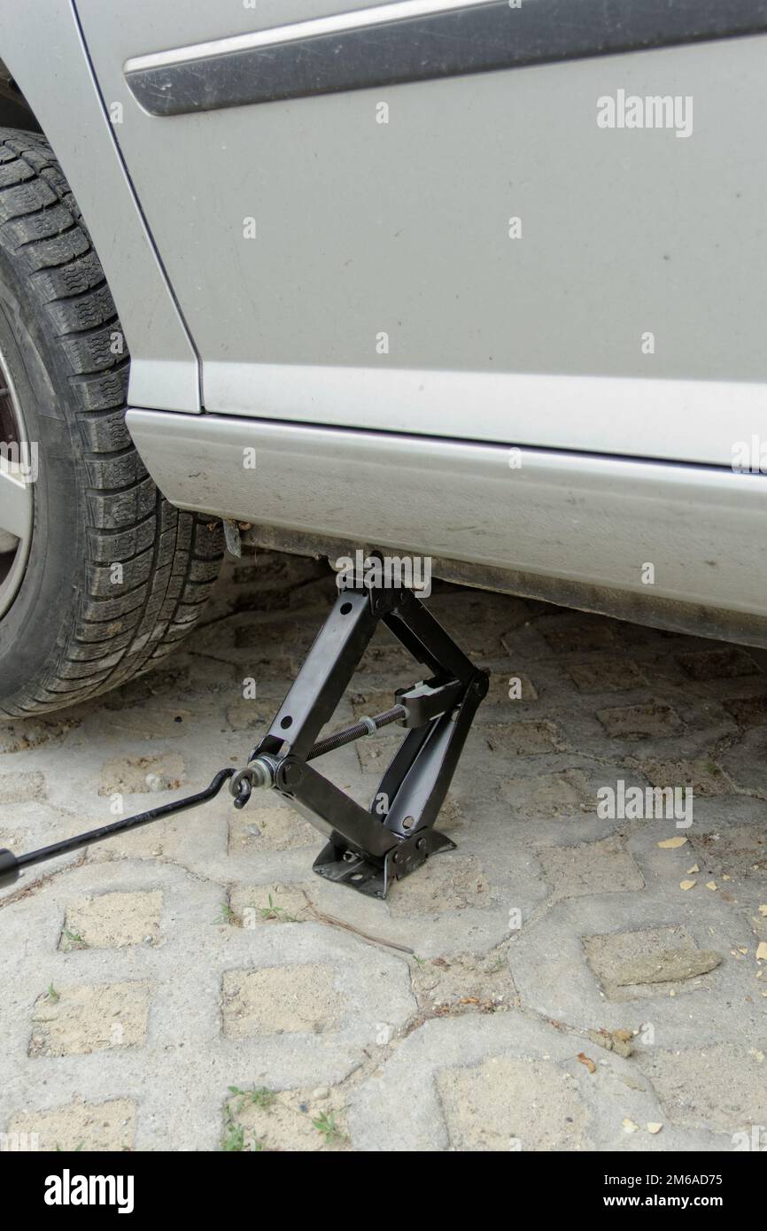 Car lifting for service with handlifter Stock Photo - Alamy