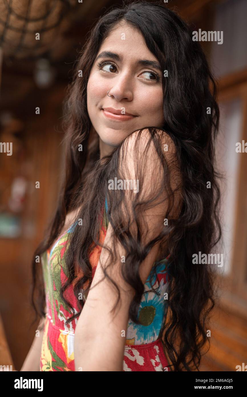 face of adorable young latin woman with long hair smiling, lifestyle ...